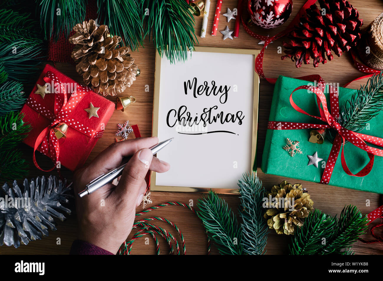 Merry christmas concepts with human hand writing cards with gift box ...