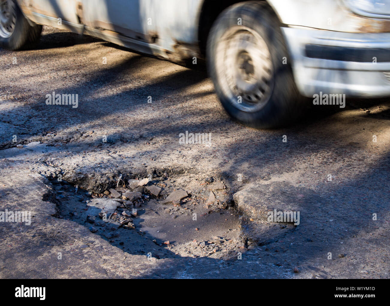 The car passes near the pit on an asphalt road Stock Photo - Alamy
