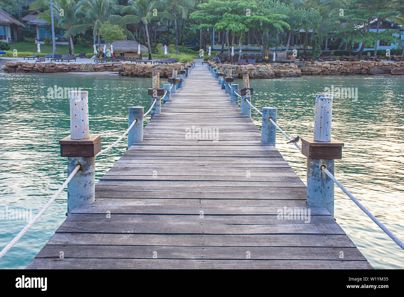 Wooden bridge pier boat in the sea and the bright sky Stock Photo - Alamy