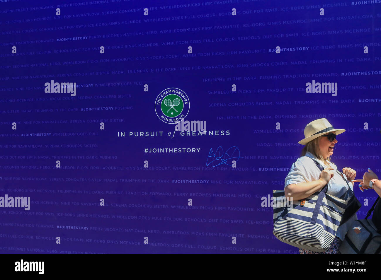 Wimbledon London, UK. 4th July 2019. Pedestrians walk past a large ...
