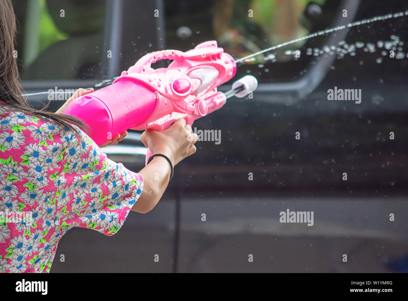 Hand holding a water gun play Songkran festival or Thai new year in ...