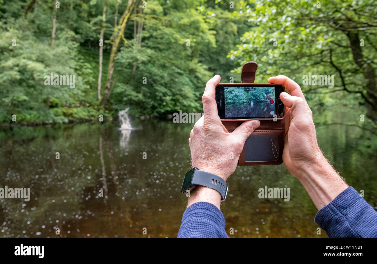 Filming stones making a splash using an iphone Stock Photo - Alamy