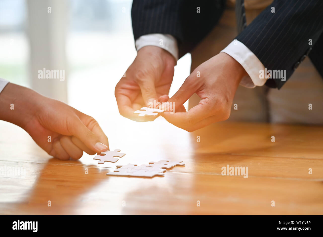 Two Businessman hand connecting jigsaw puzzle. business solutions ...