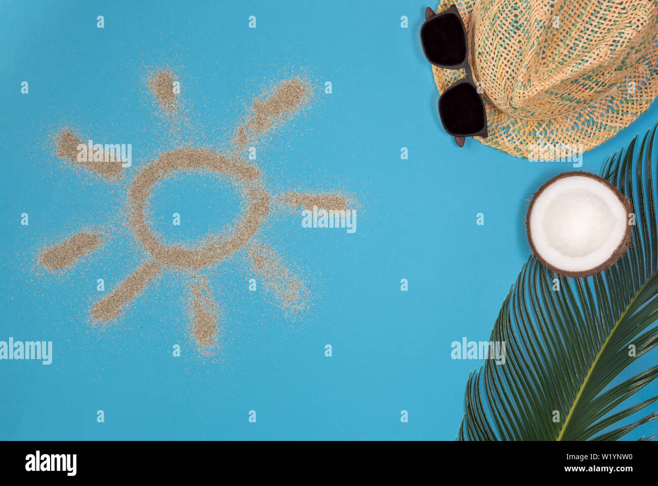 Beach theme on blue background. Sun drawn by the sand on blue ...