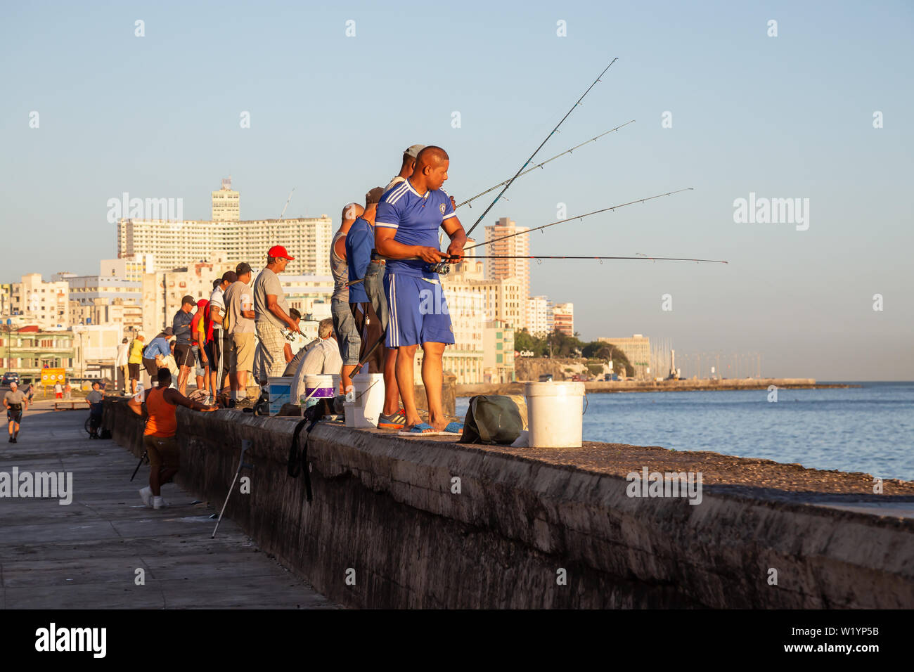Havana, Cuba - May 21, 2019: Cuban people are fishing in the ocean ...