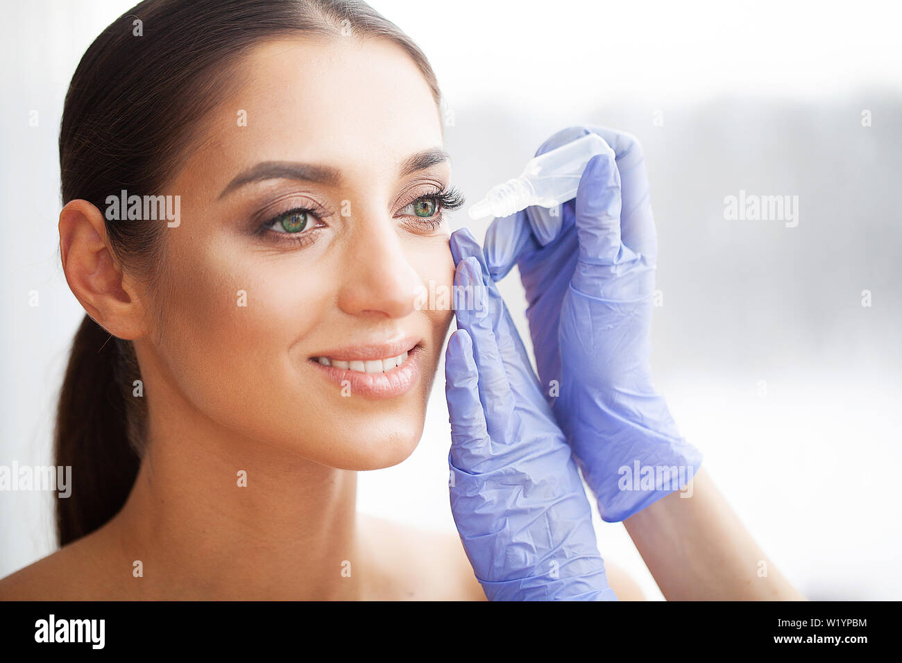 Health and Beauty. Eye Care. Beautiful Young Woman Holding Drops For ...