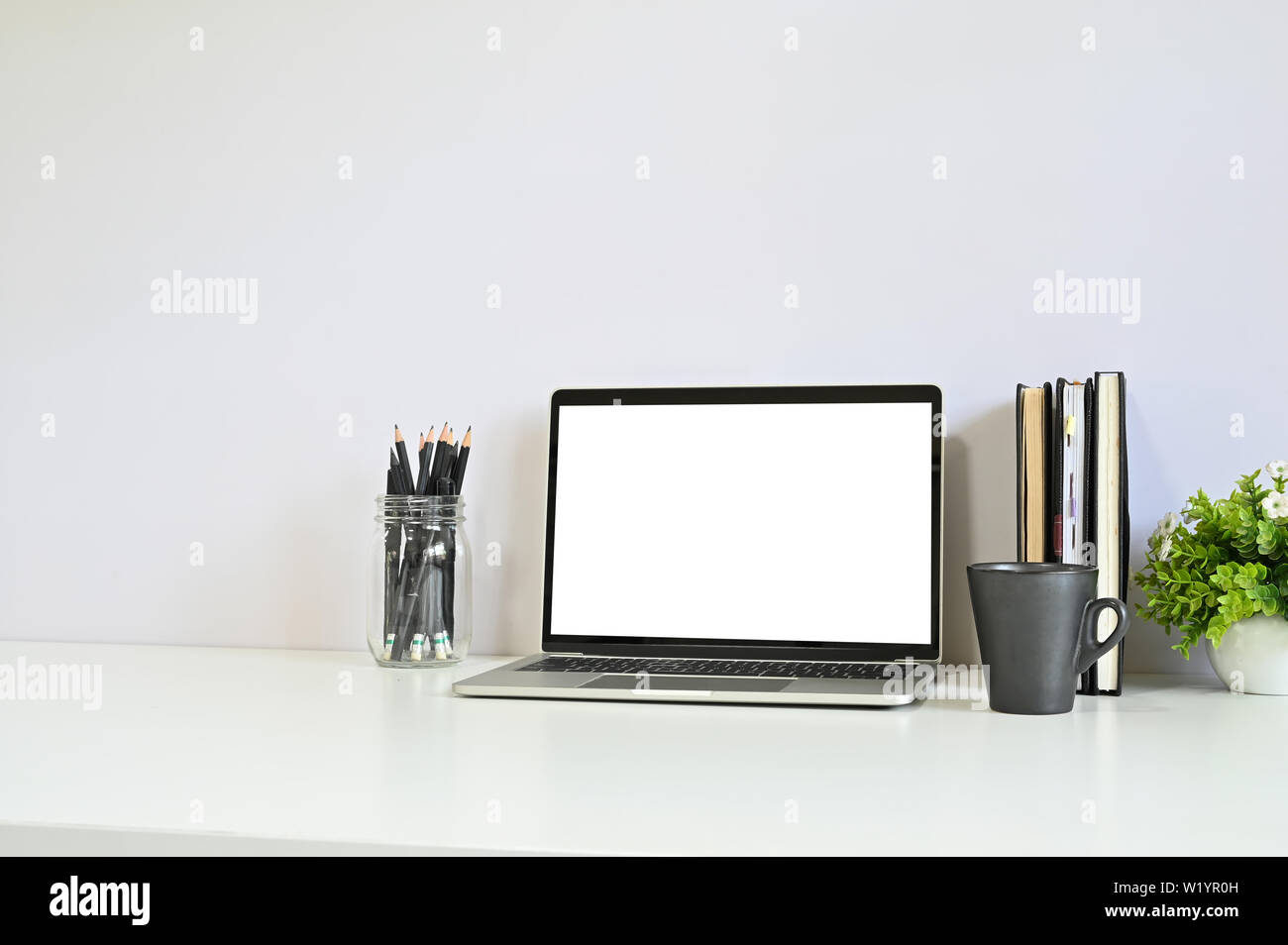 Workspace laptop, coffee, pencil and notebook on office table with copy ...