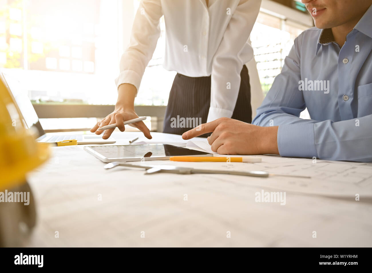 Architect planning blueprint in digital tablet with construction ...