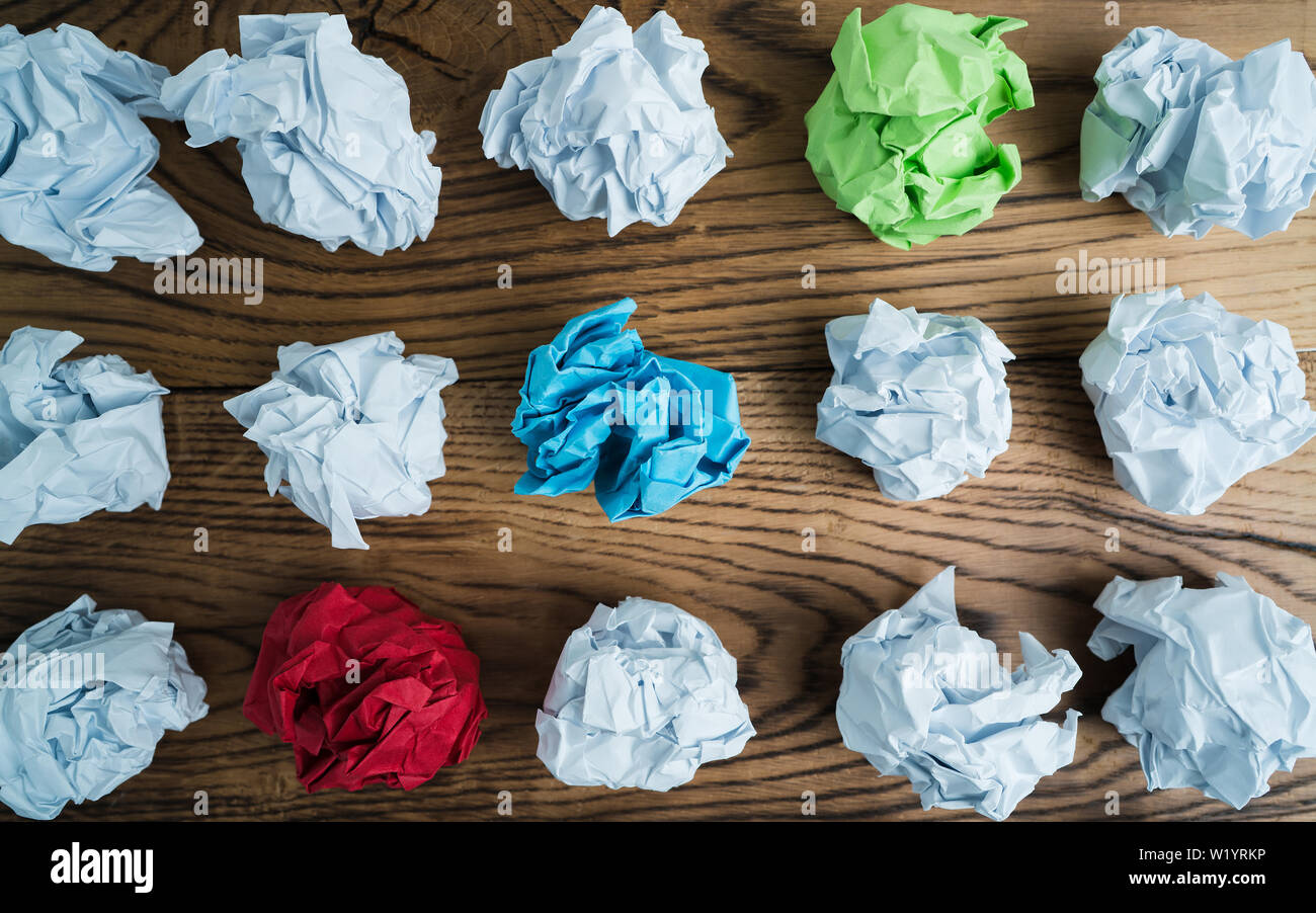 crumpled paper symbolizing different solutions with some standing out ...