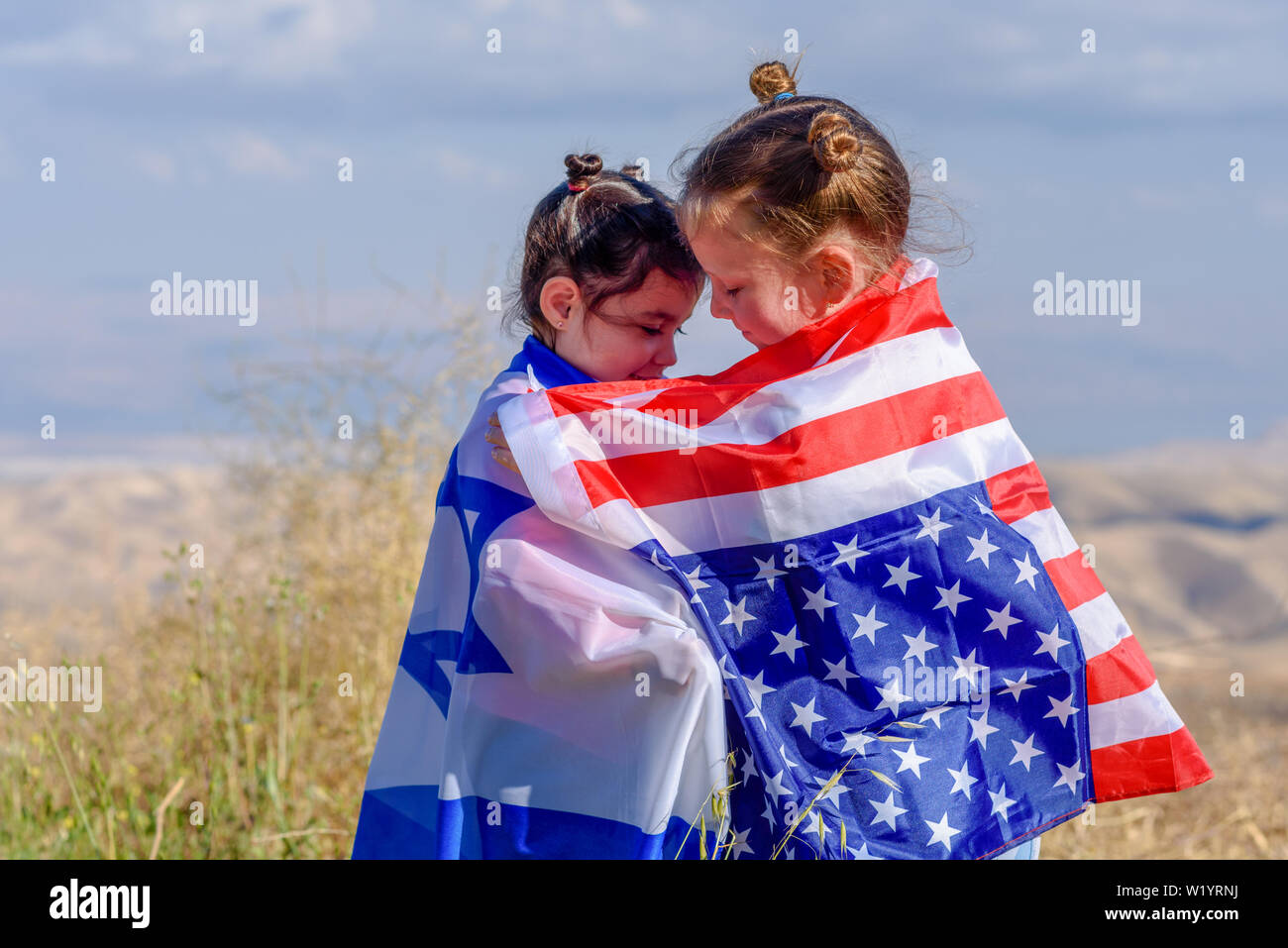 Two cute girls with American and Israel flags. Little children holding ...