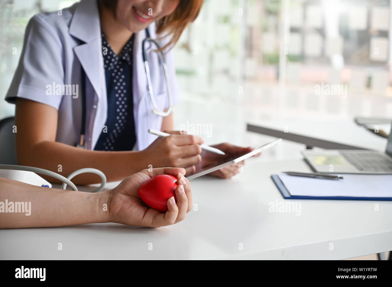 Doctor checking blood pressure patient using hi-res stock photography ...