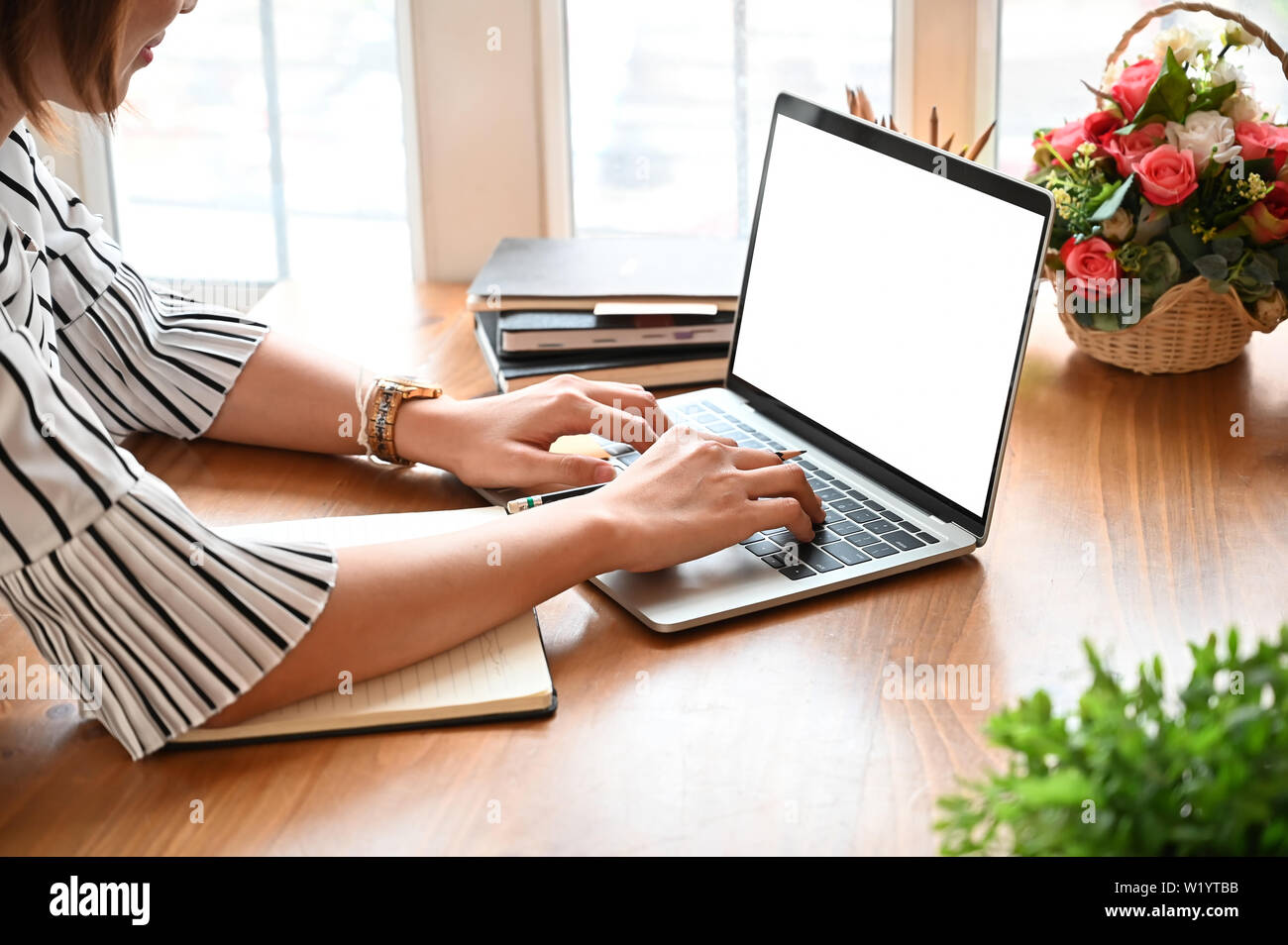 Female using mockup laptop computer montage screen with cropped shot ...
