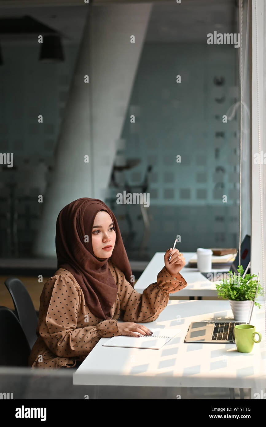Muslim female using laptop computer on office desk Stock Photo - Alamy