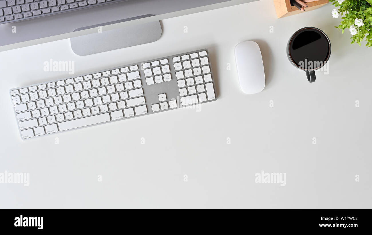 Office desk computer, keyboard, mouse and coffee on white table Stock ...