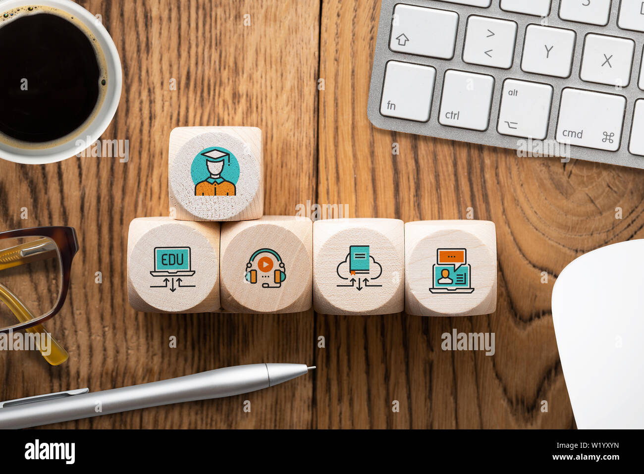 components of digital learning as icons on cubes on wooden background ...