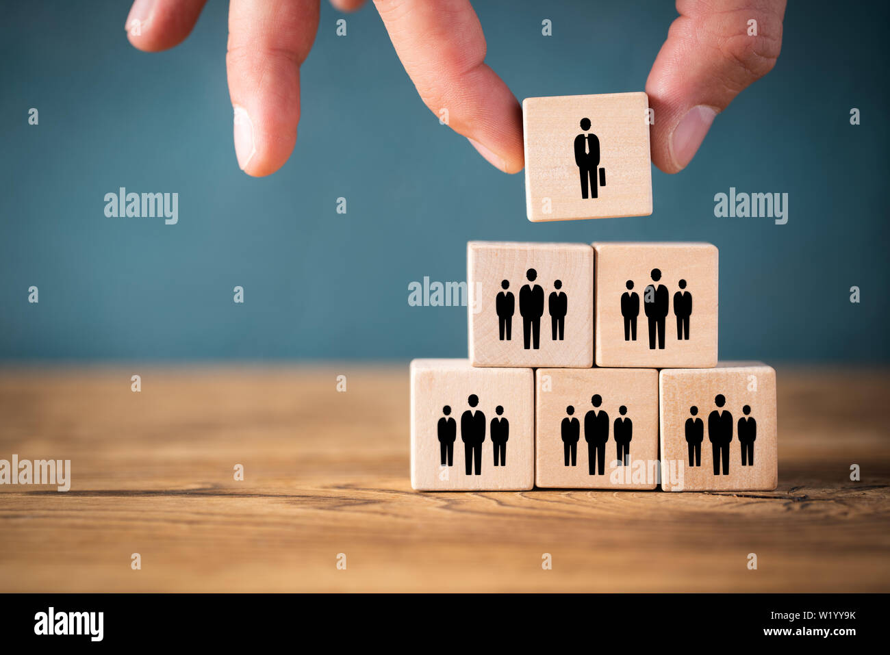 organization and team structure symbolized with cubes on wooden ...