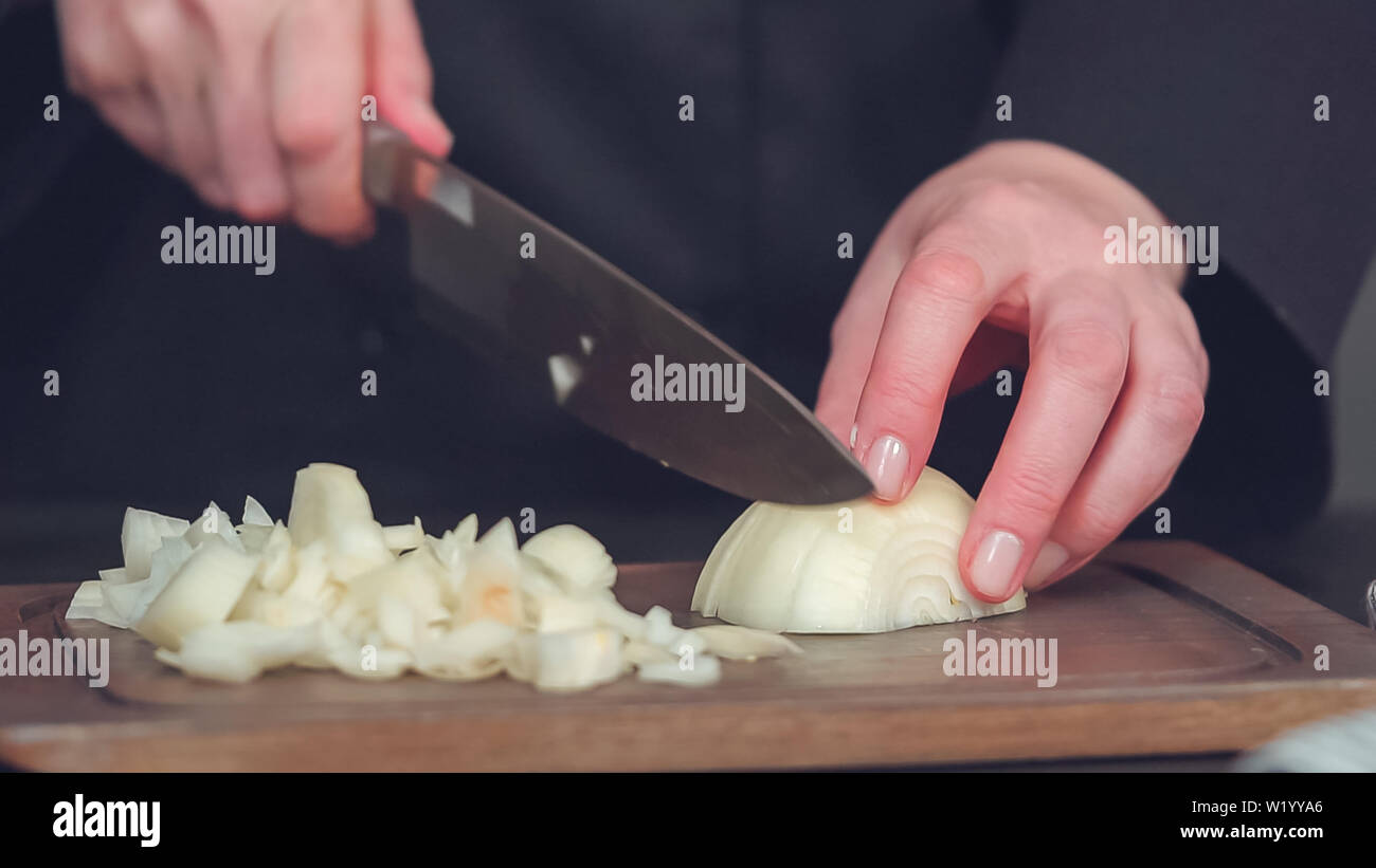 Step by step. Dicing yellow onion on a wood cutting board Stock Photo ...