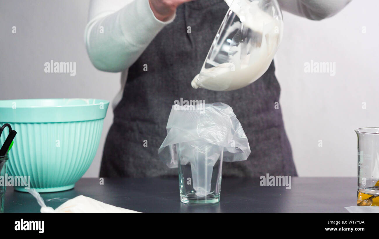 Step by step. Pouring royal icing into the piping bag to decorate sugar ...