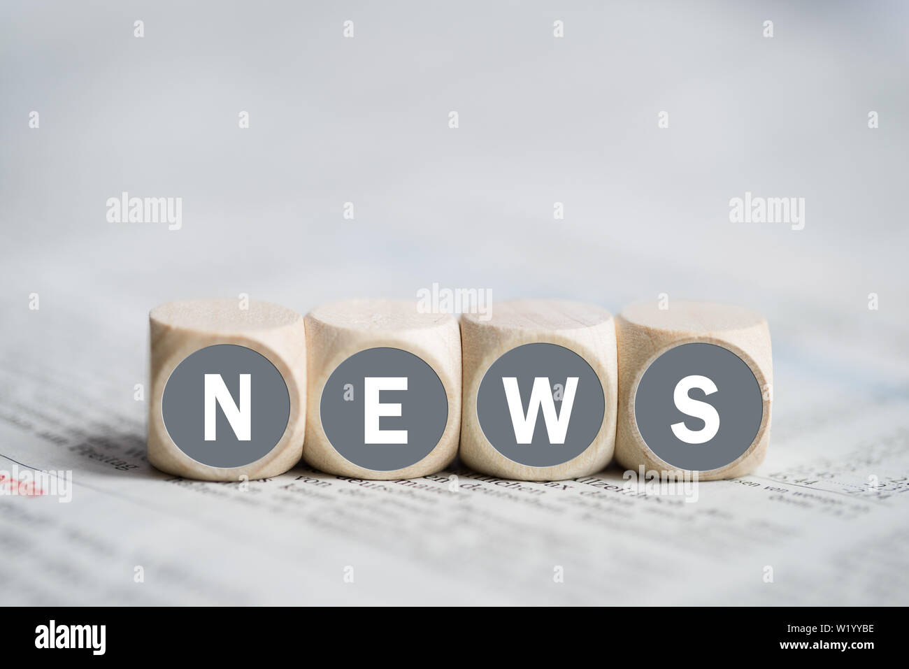 cubes with the word "news" on a newspaper Stock Photo - Alamy
