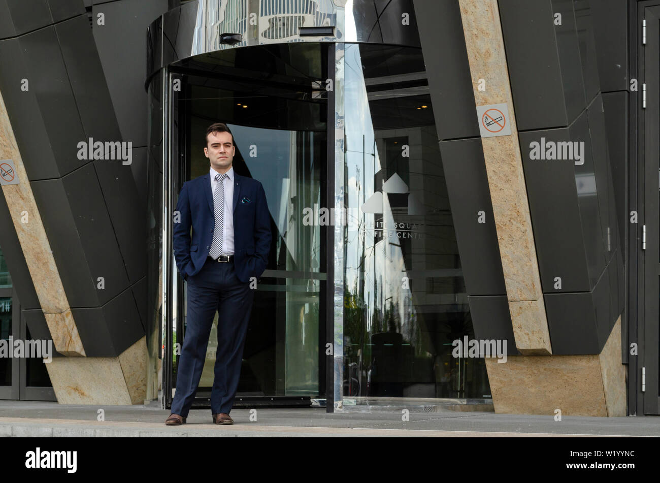 Businessman portrait in the middle of business center, work break ...