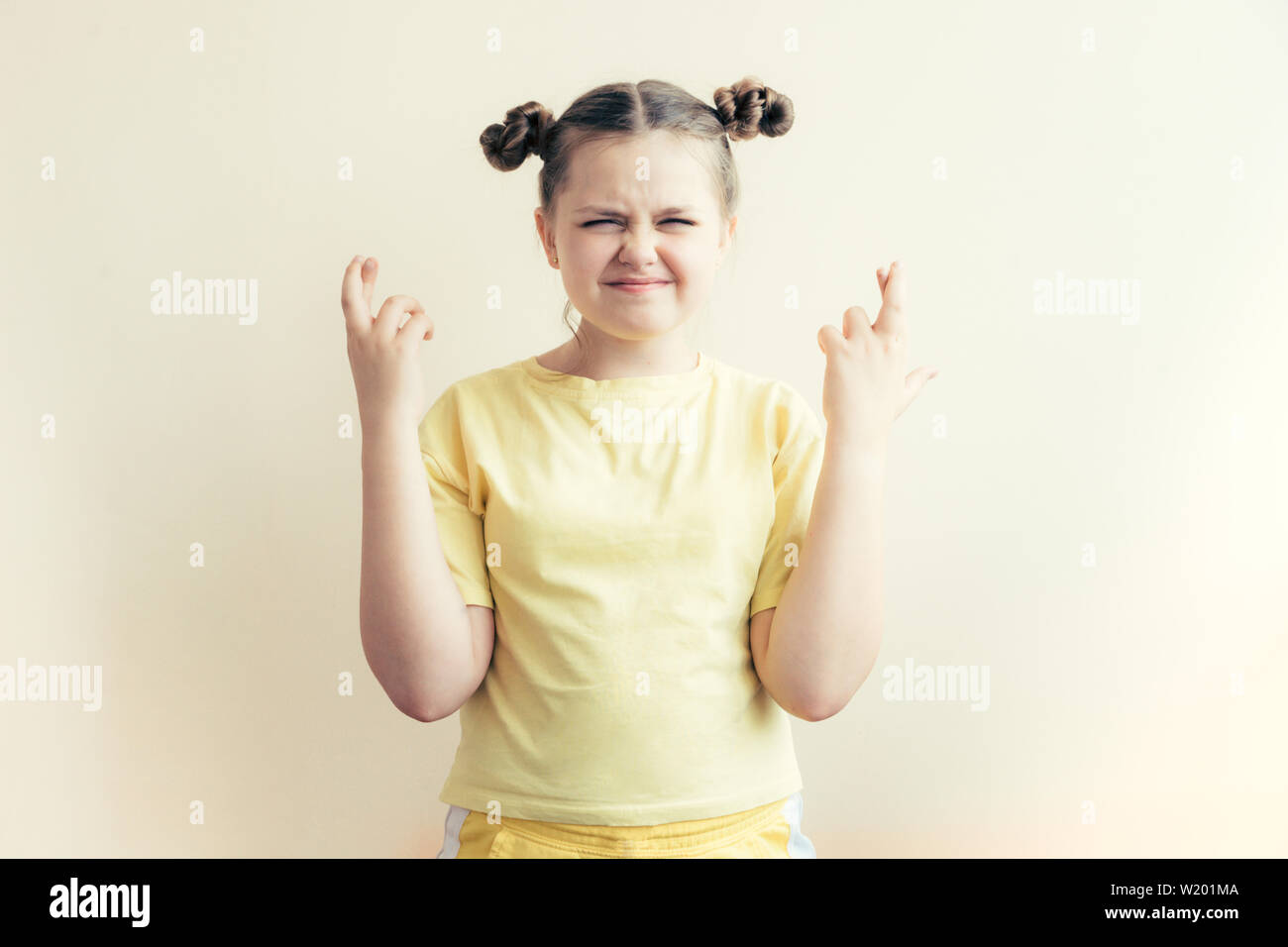 Teenager girl crossed her fingers and squeezed eyes shut in ...