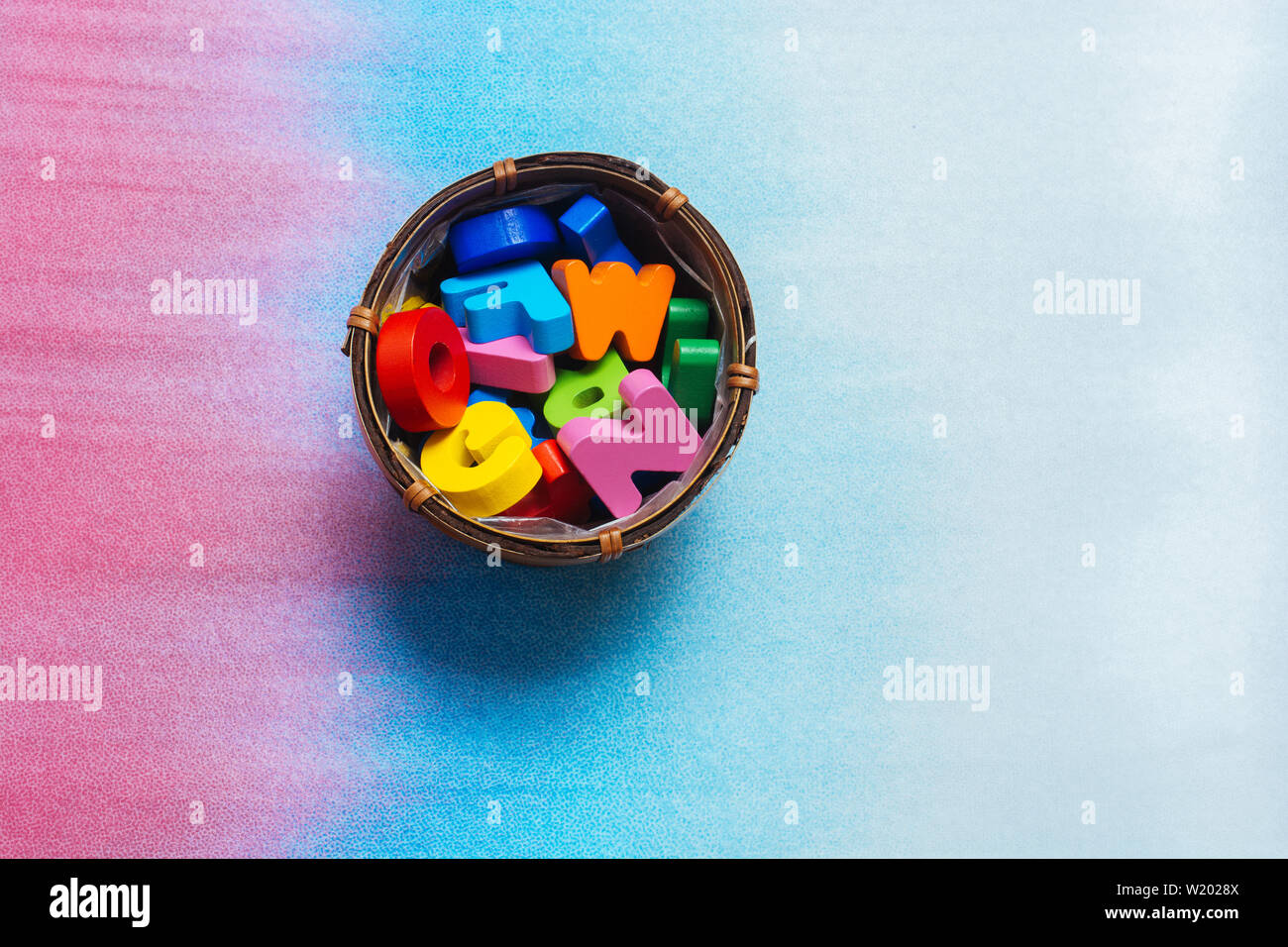 Colorful wooden letters in a container on a colorful background Stock ...