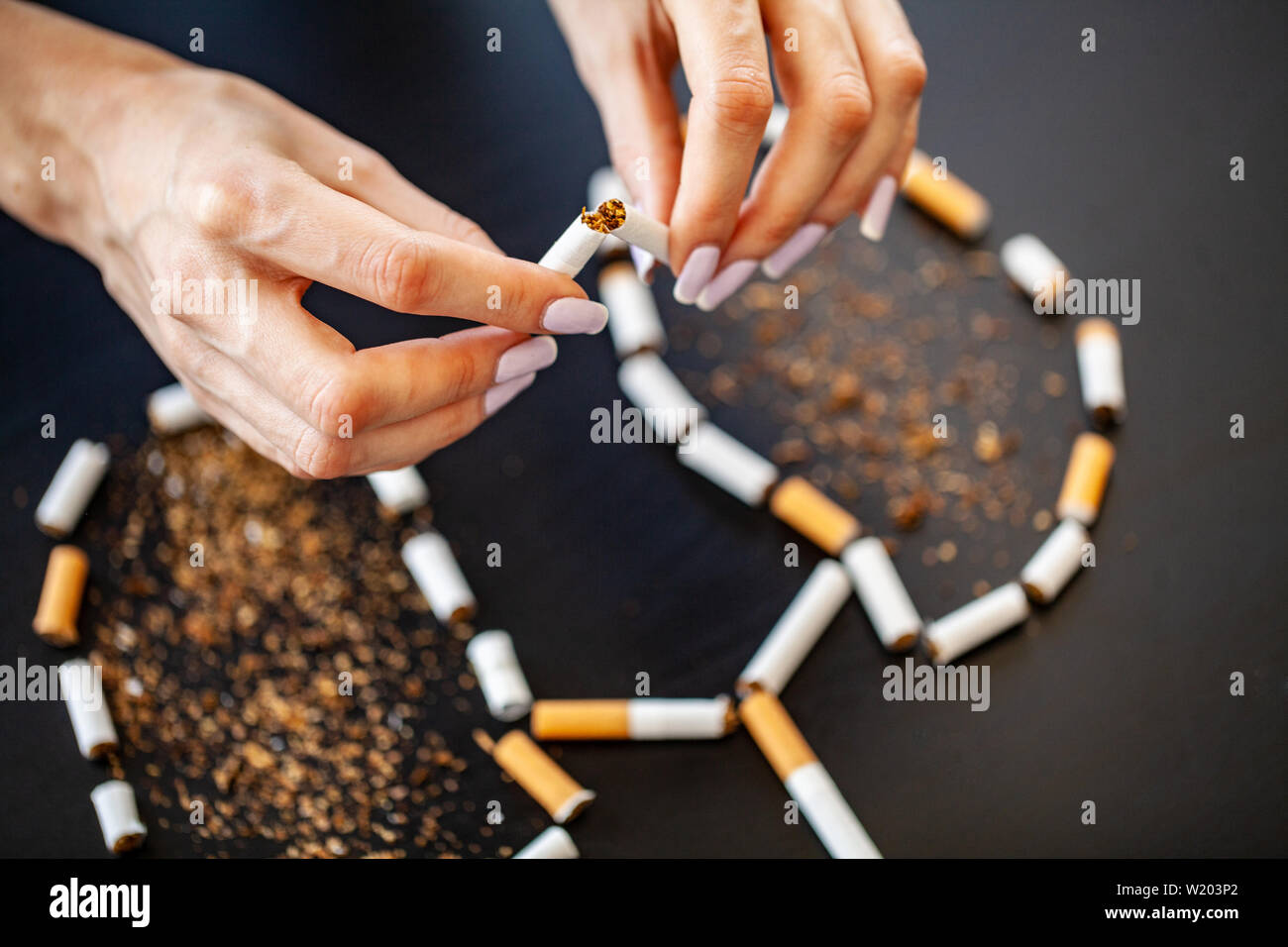 Stop smoking concept on background with broken cigarettes. Heap of ...