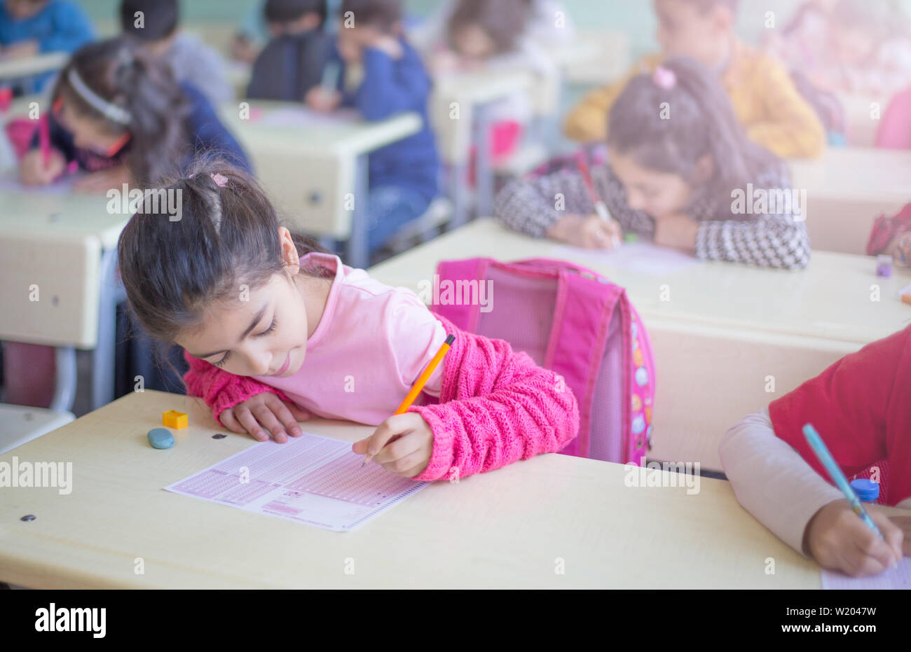 elementary school girl filling optical form in classroom Stock Photo ...