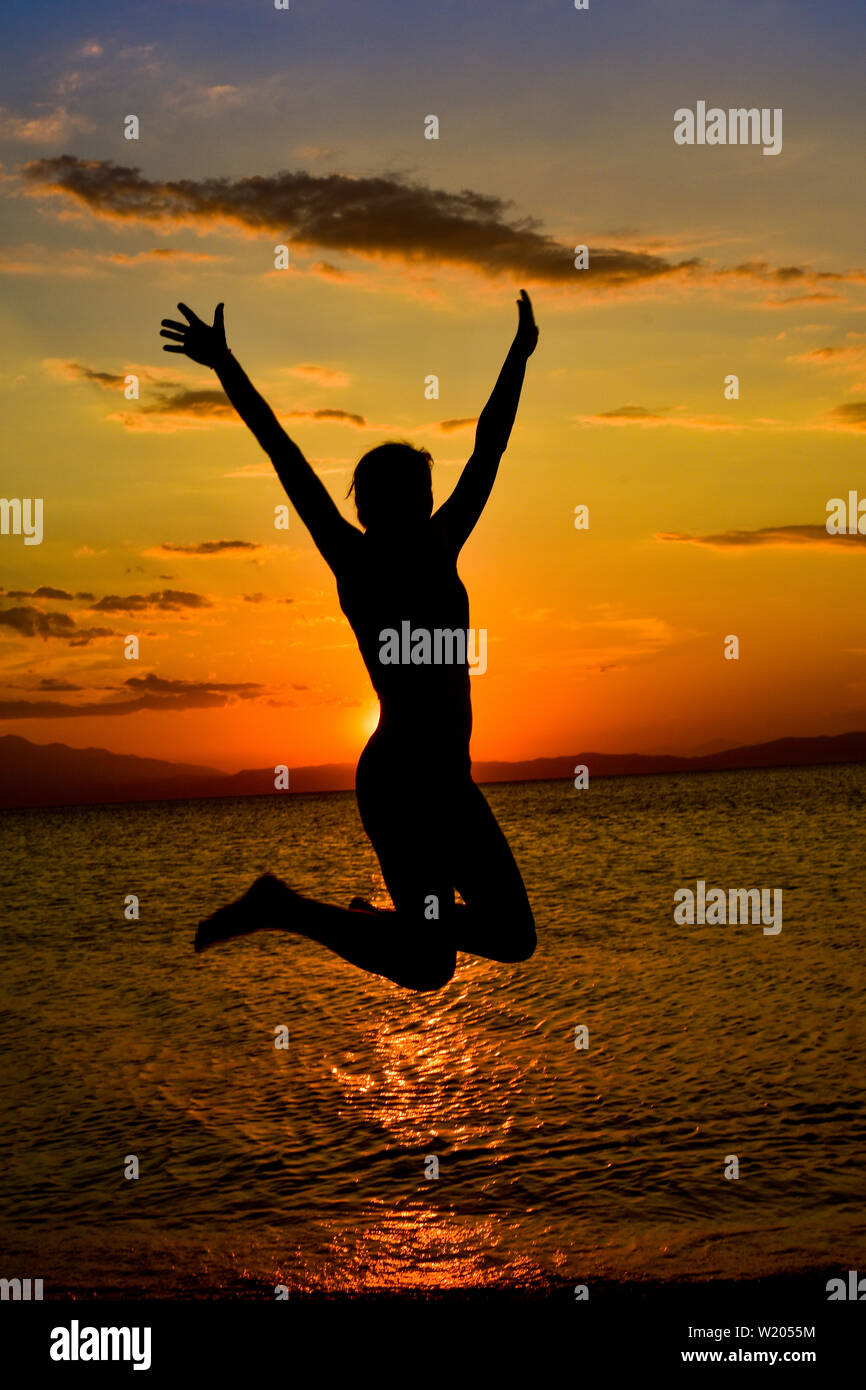 Happy woman jumping against beautiful sunset. Freedom Stock Photo - Alamy