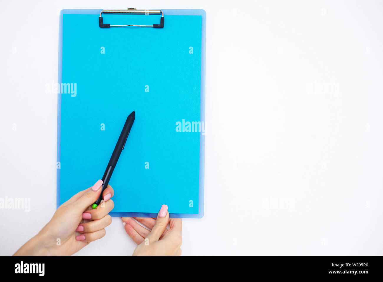 Blank Folder with Blue Paper. Hand that Holding Folder and Pen on White ...