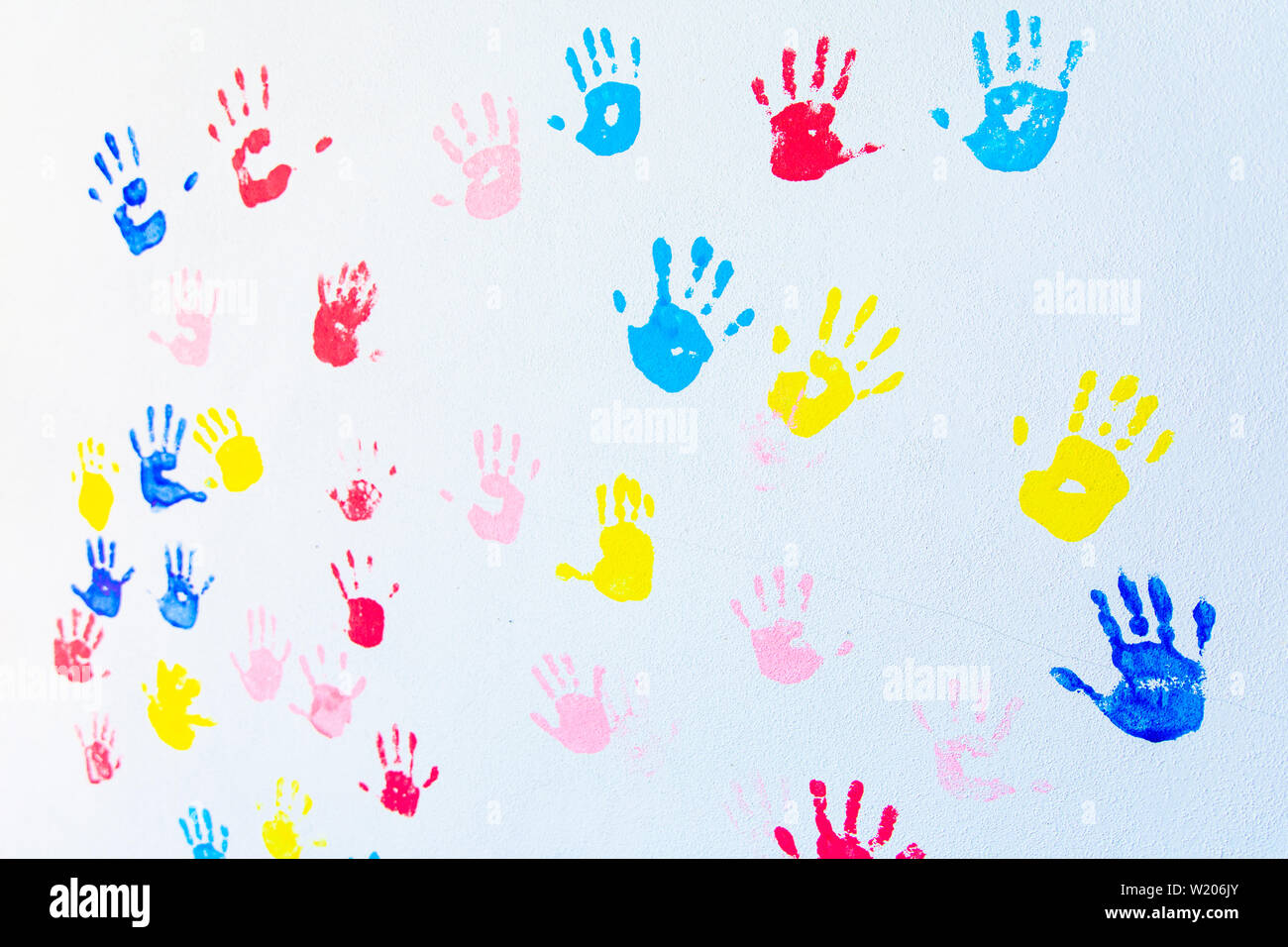Colorful hand prints of hands isolated on white wall background ...