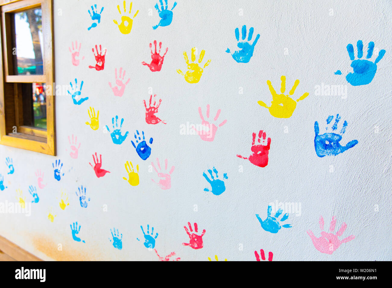 Colorful hand prints of hands isolated on white wall background ...