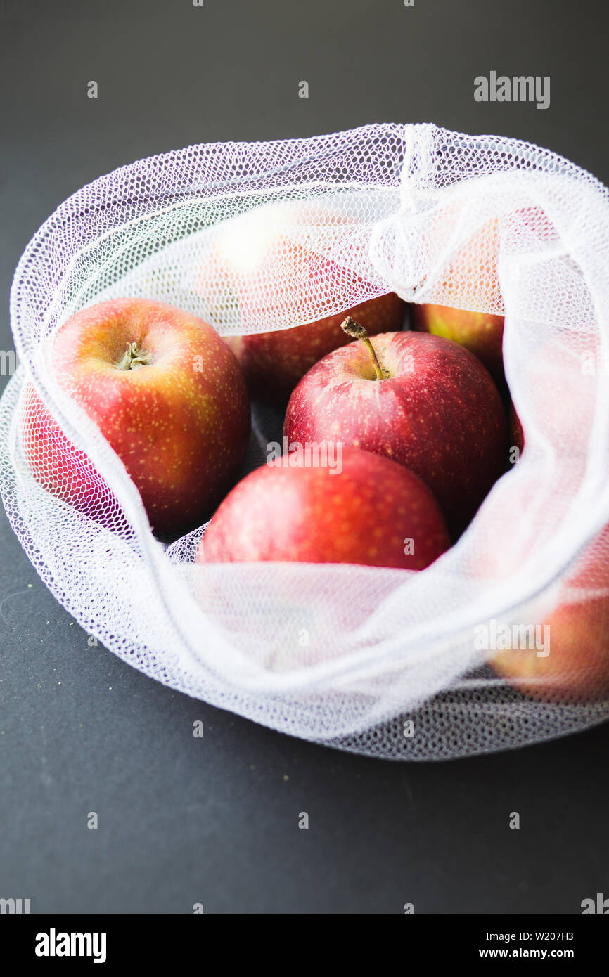 Reusable eco-friendly bag full of fresh seasonal apples. Caring for the ...