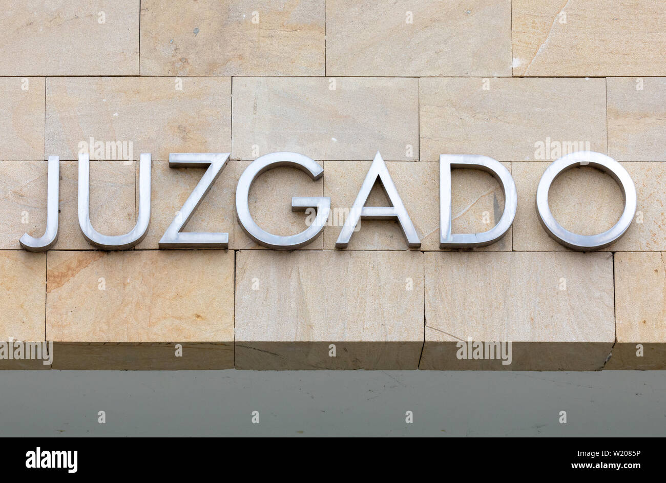 Word judged in Spanish. Court sign (justice) in metallic letters Stock ...