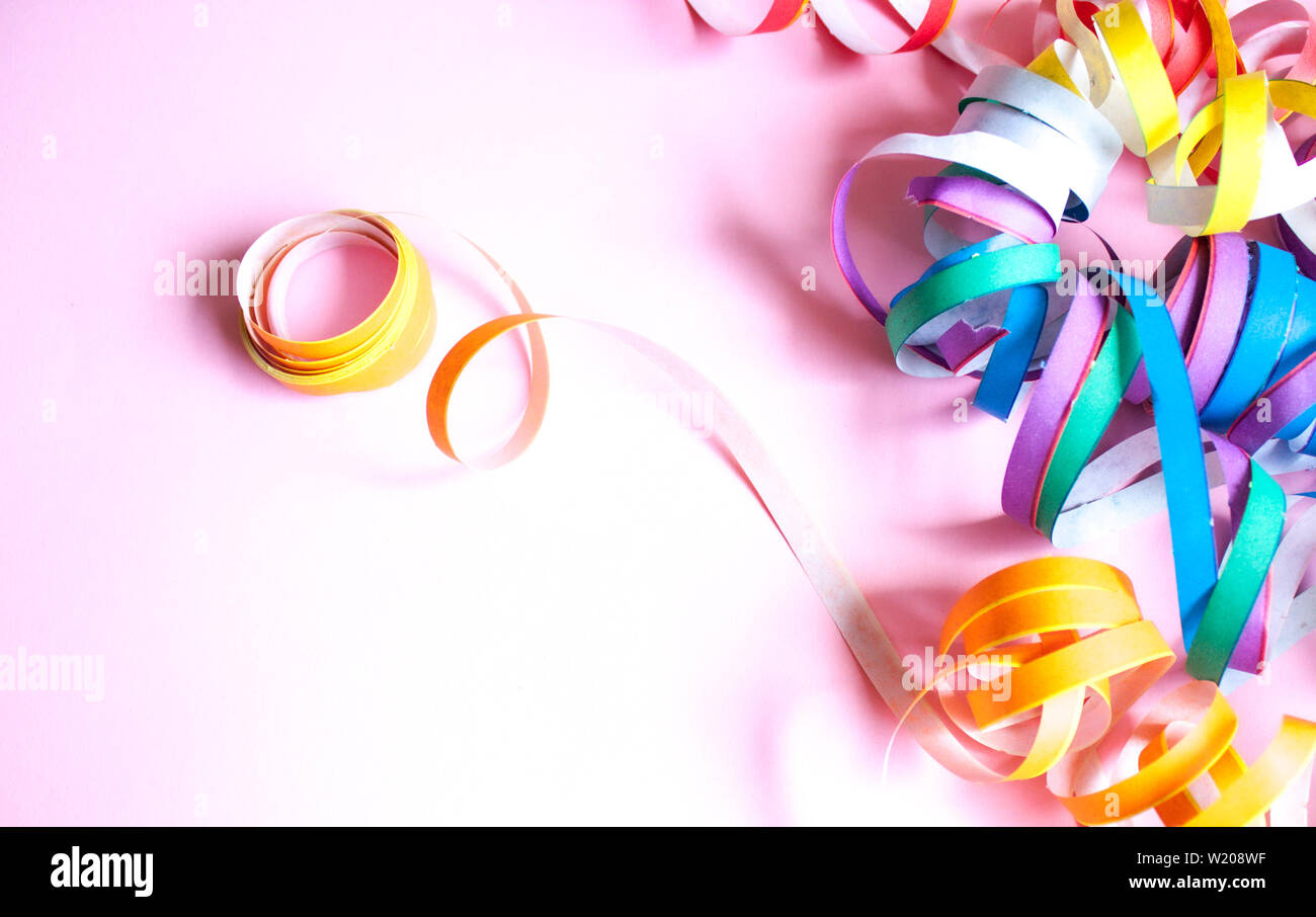 Multicolored ticker tape decorations on soft pink background Stock ...