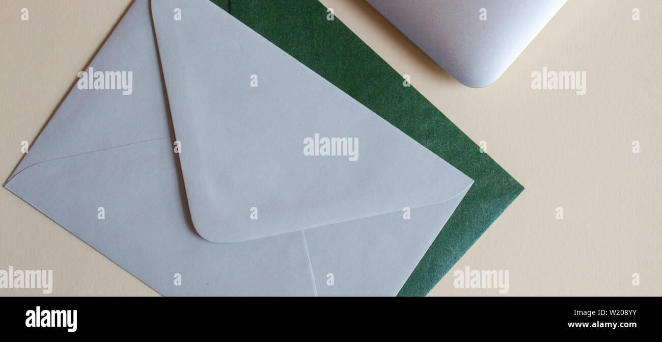 Colorful envelopes, laptop and cardboards on table. Mockup. Office ...