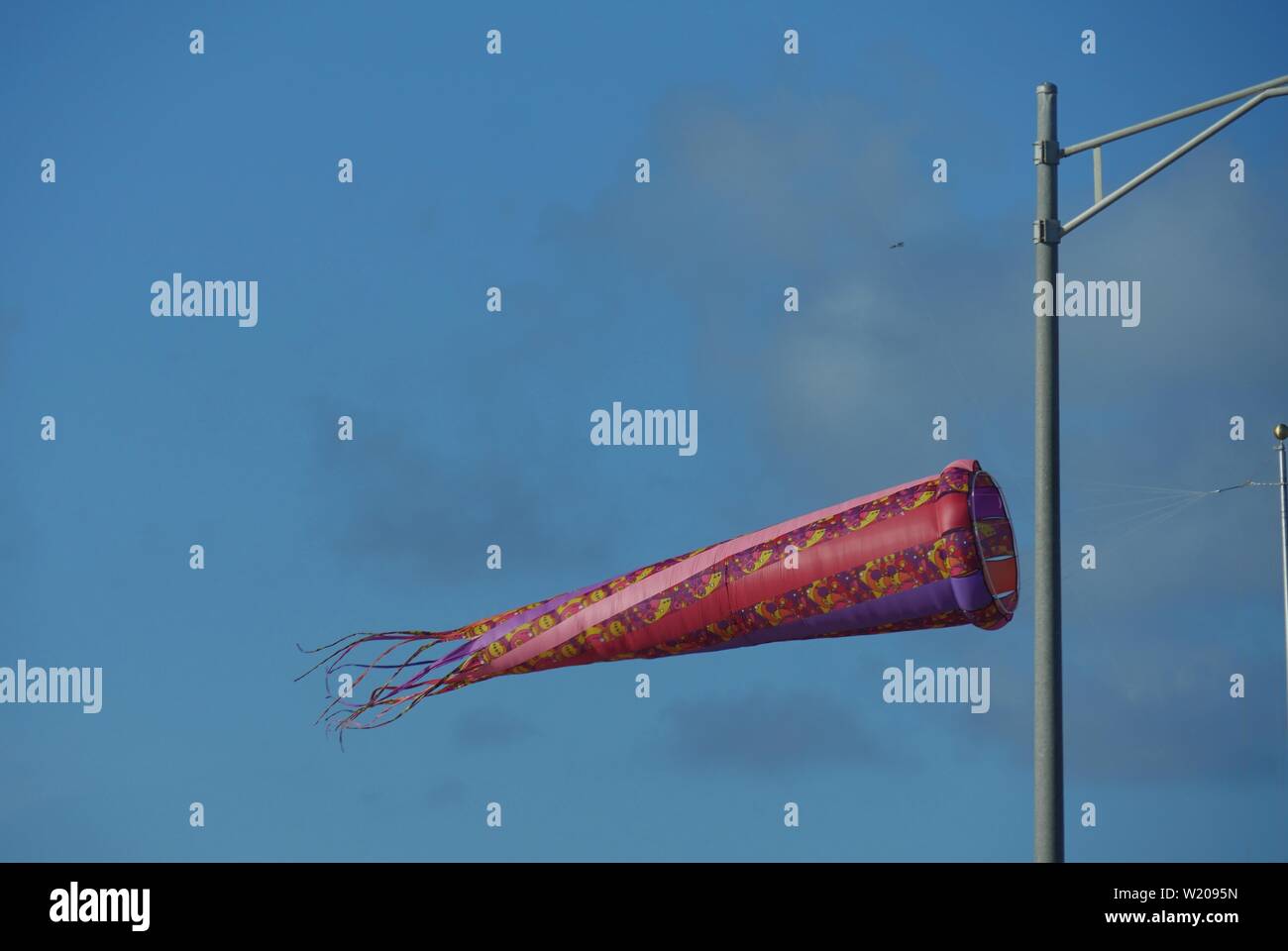 Colorful lantern flying close to a metal pole in the skies Stock Photo ...