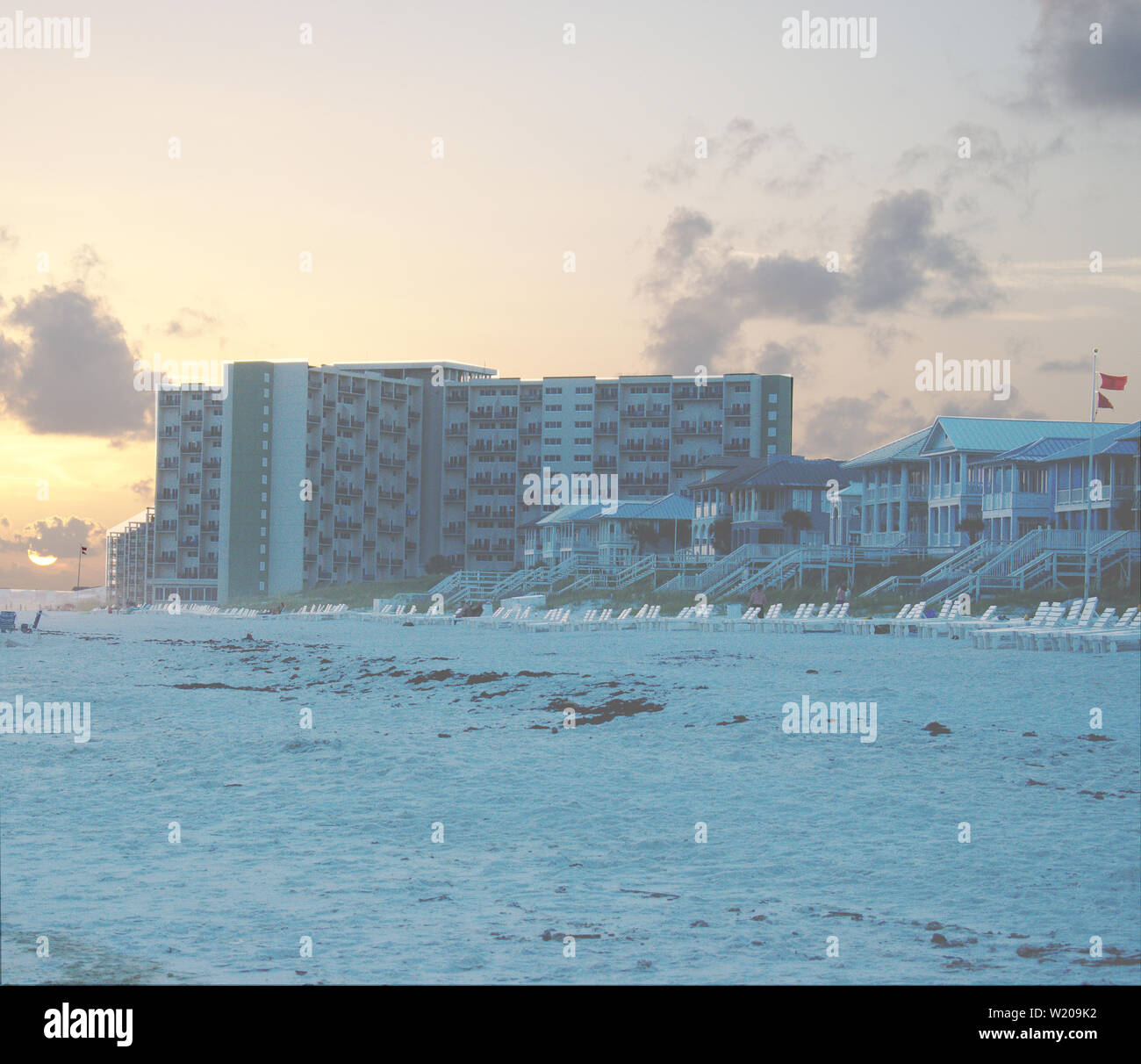 Sun setting on the beach Stock Photo - Alamy