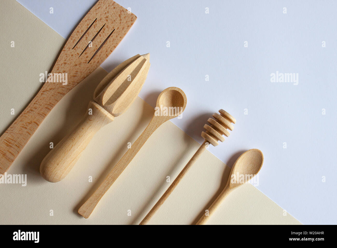 Handmade wooden cutlery on beige white background, wood kitchen tools ...