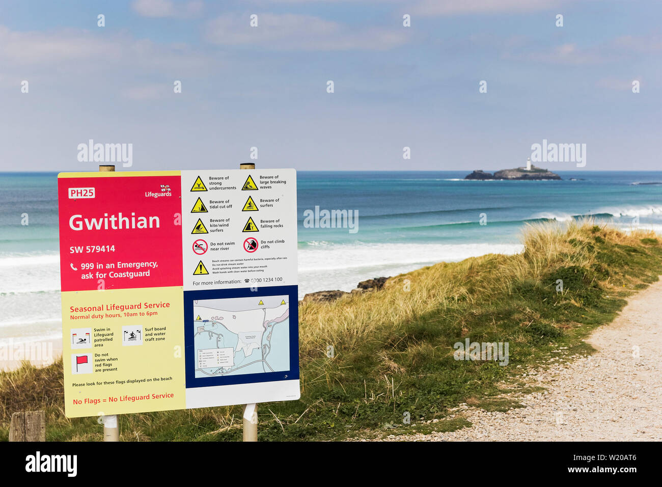 Coastal path at Gwithian, Cornwall, UK with warning board and Godrevy ...