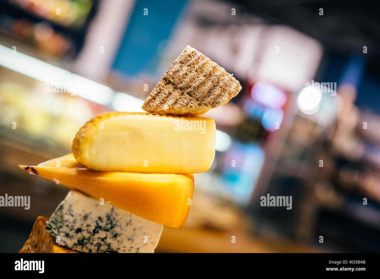 Assorted, various aged cheeses on plate or board. Different kind or ...