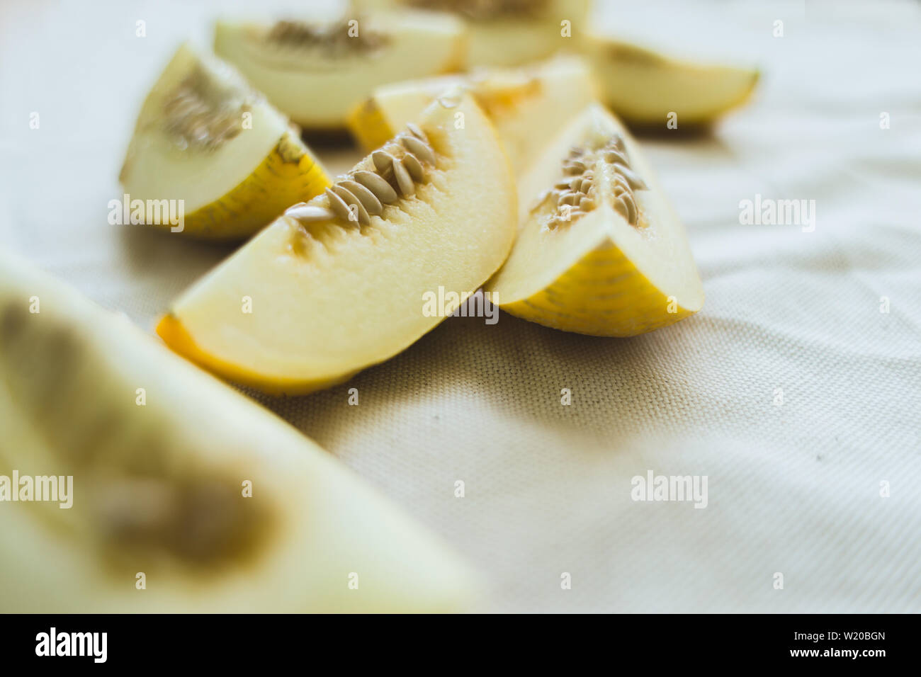 A group of brightly lit melon slices. seasonal summer fruits Stock ...
