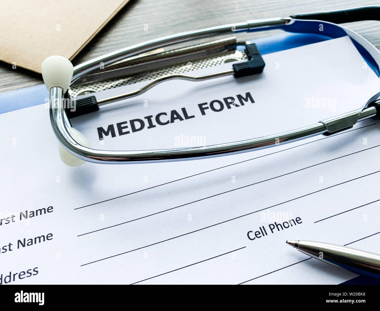 Medical form with patient data on doctor's desk Stock Photo - Alamy