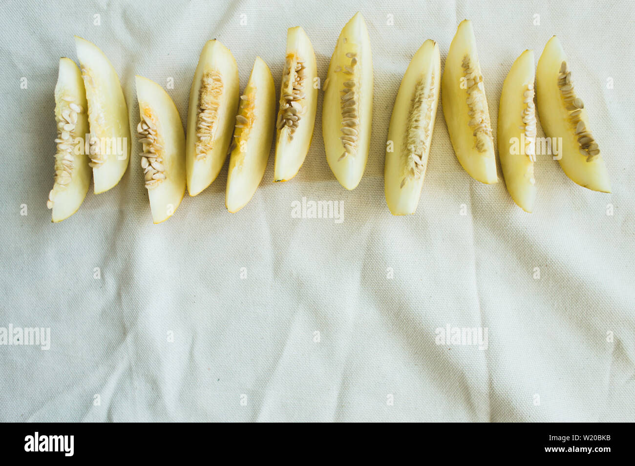 A group of brightly lit melon slices. seasonal summer fruits Stock ...