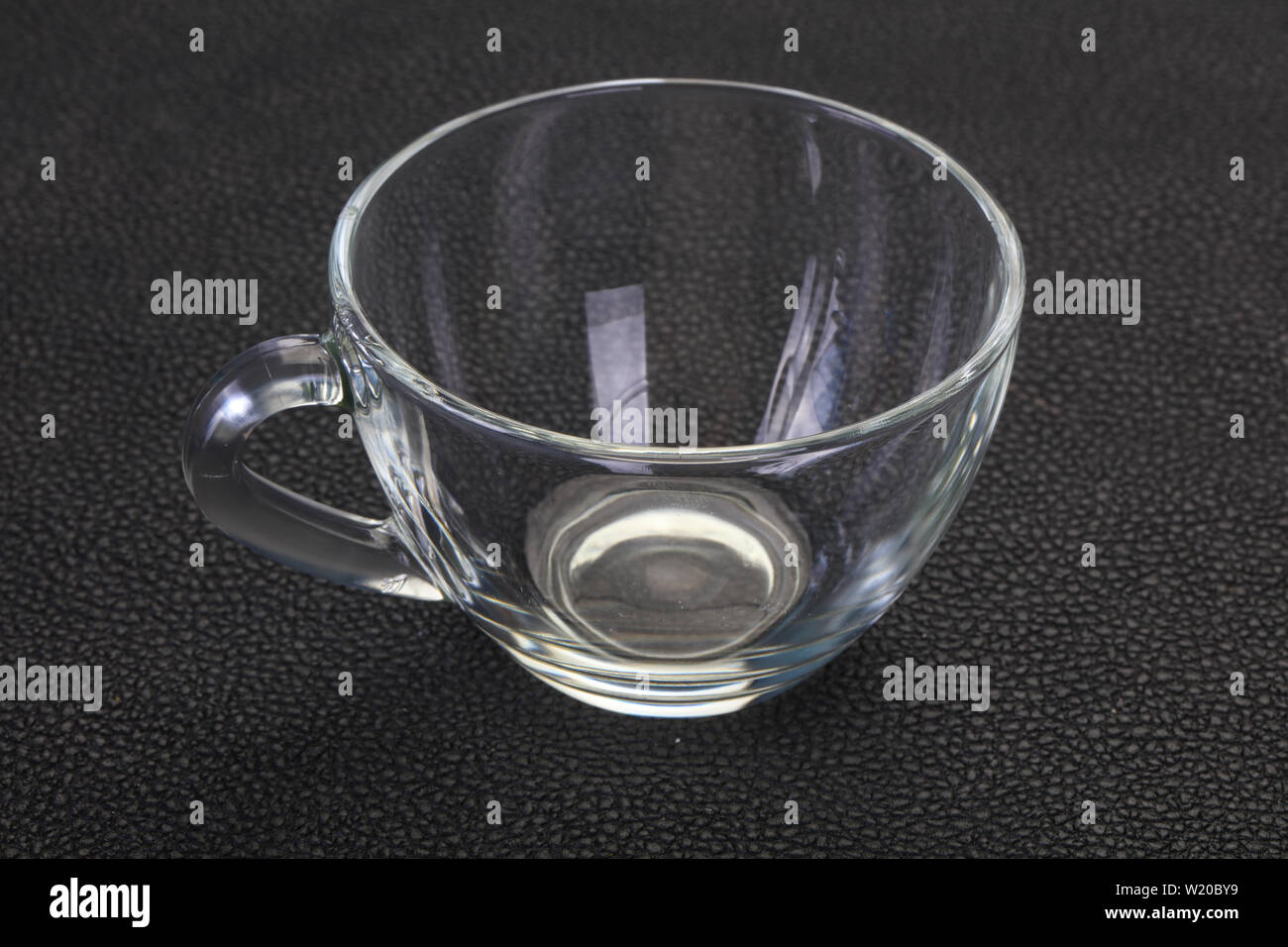 Empty glass cup over black background Stock Photo - Alamy