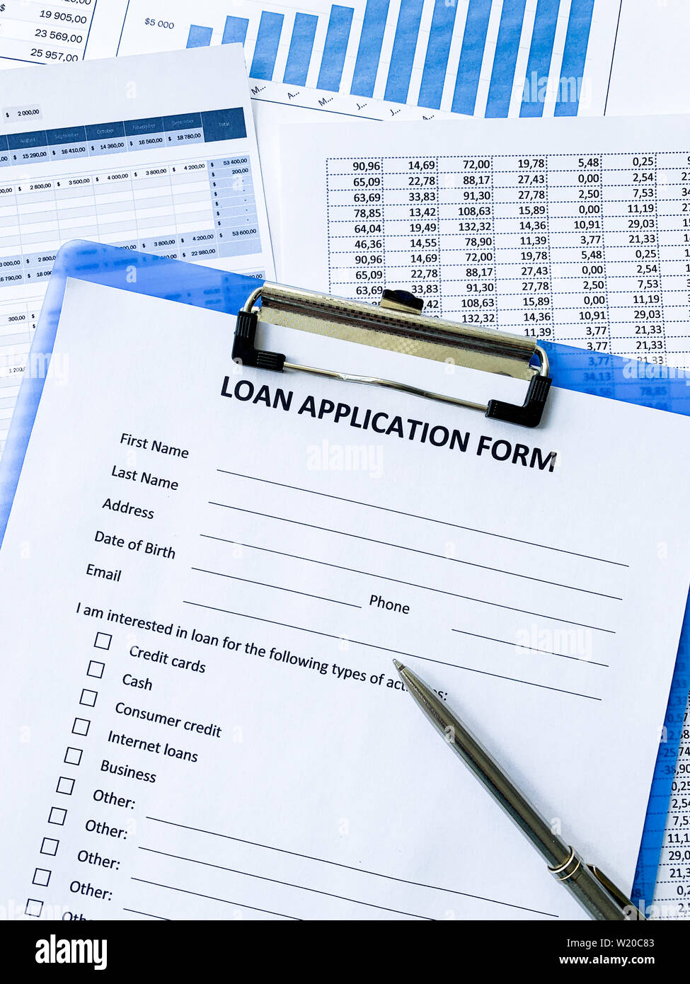 Loan application form document with graph on table Stock Photo - Alamy
