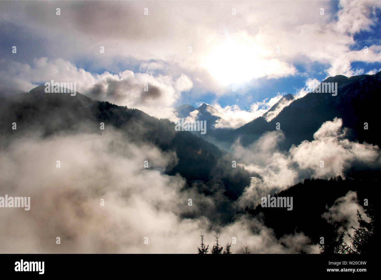 Clouds in front of the sun and blue sky in the Austrian Alps Stock ...