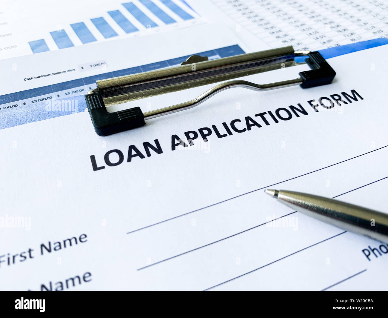 Loan application form document with graph on table Stock Photo - Alamy