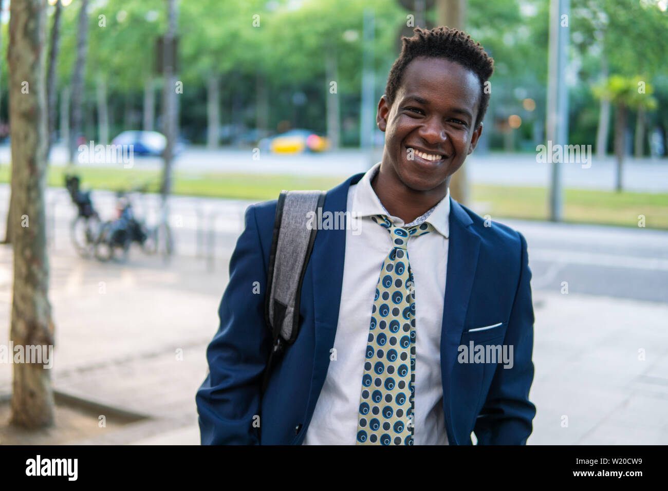 African American businessman holding laptop notebook wearing blue suit ... African American businessman holding laptop notebook wearing blue suit ...