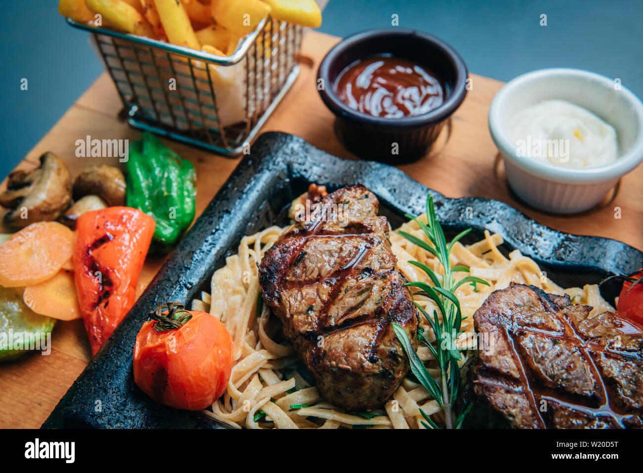 Grilled or roasted beef steak meat and pasta food meal with french ...